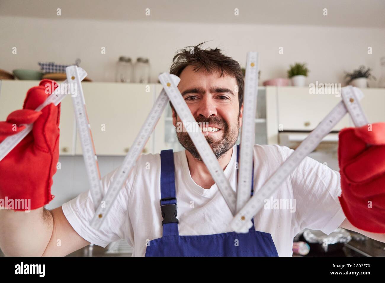 Smiling handyman with a folding rule as a symbol for do-it-yourself and ...