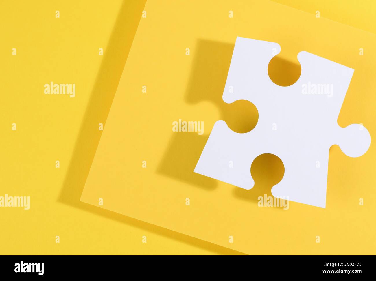 large blank white paper puzzle with shadow on yellow background, top ...