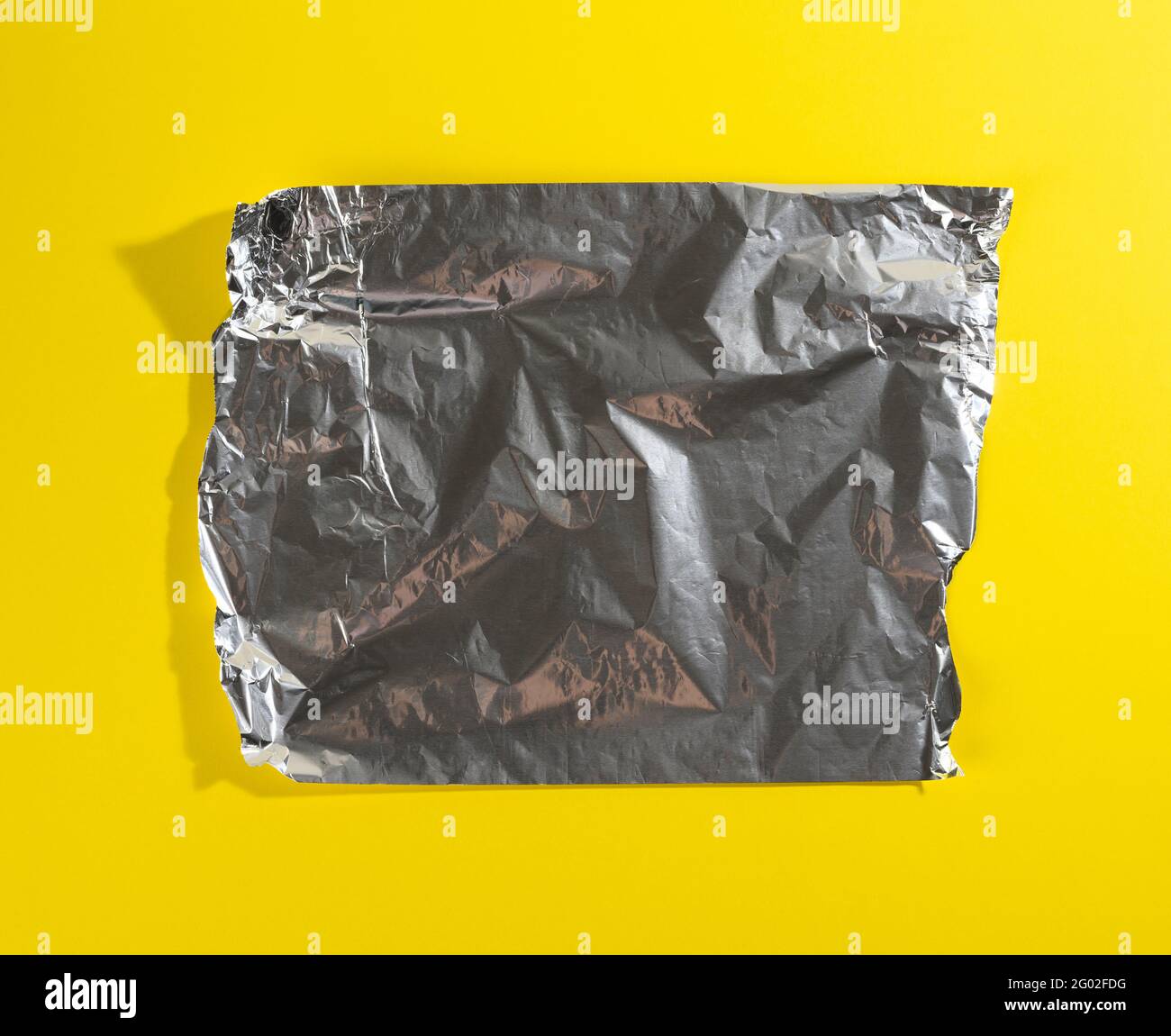 a crumpled sheet of gray foil for packaging products with torn edges on ...