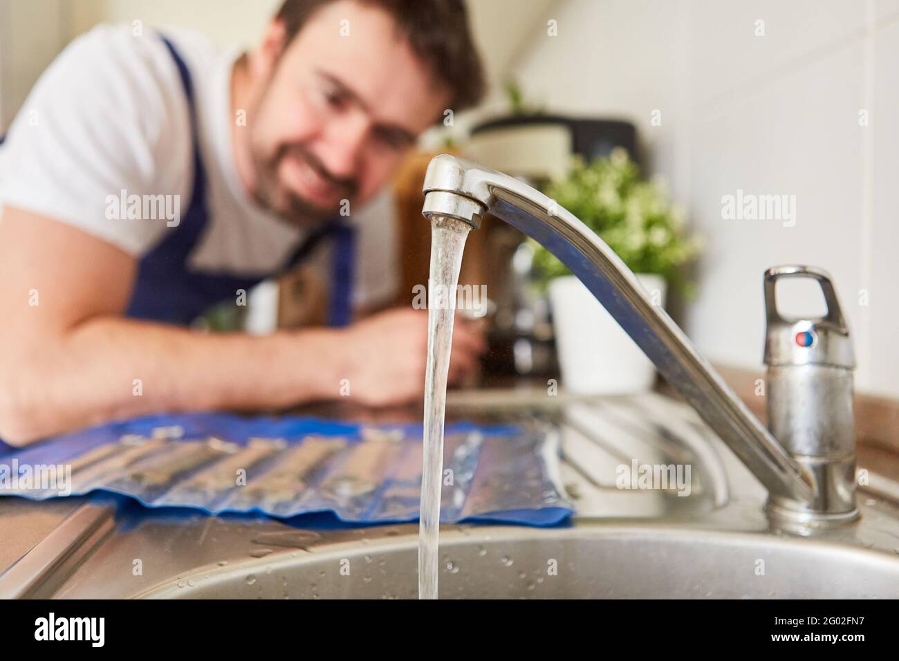 Man fitting tap on kitchen sink hi-res stock photography and images - Alamy
