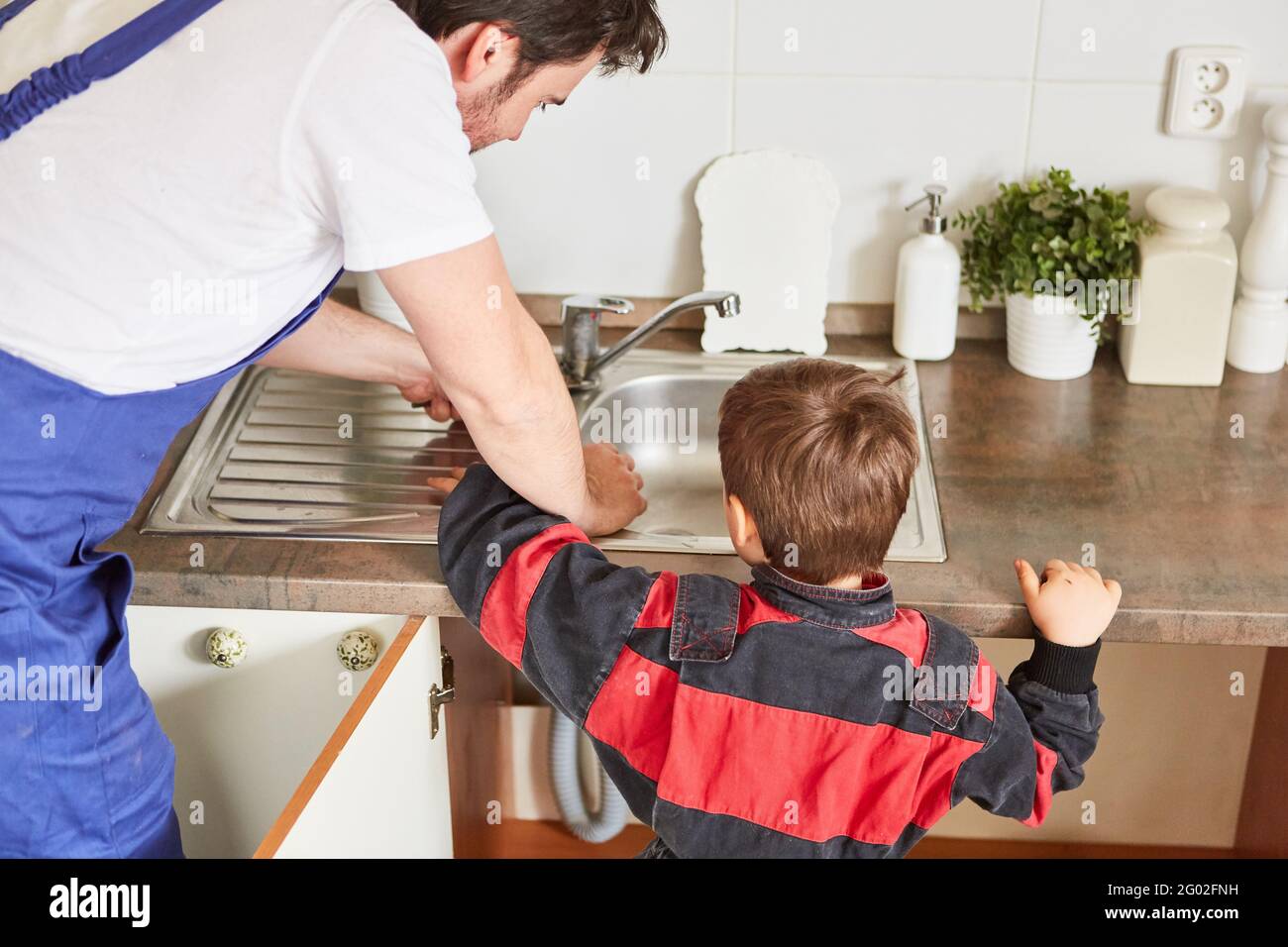 Man fitting tap on kitchen sink hi-res stock photography and images - Alamy