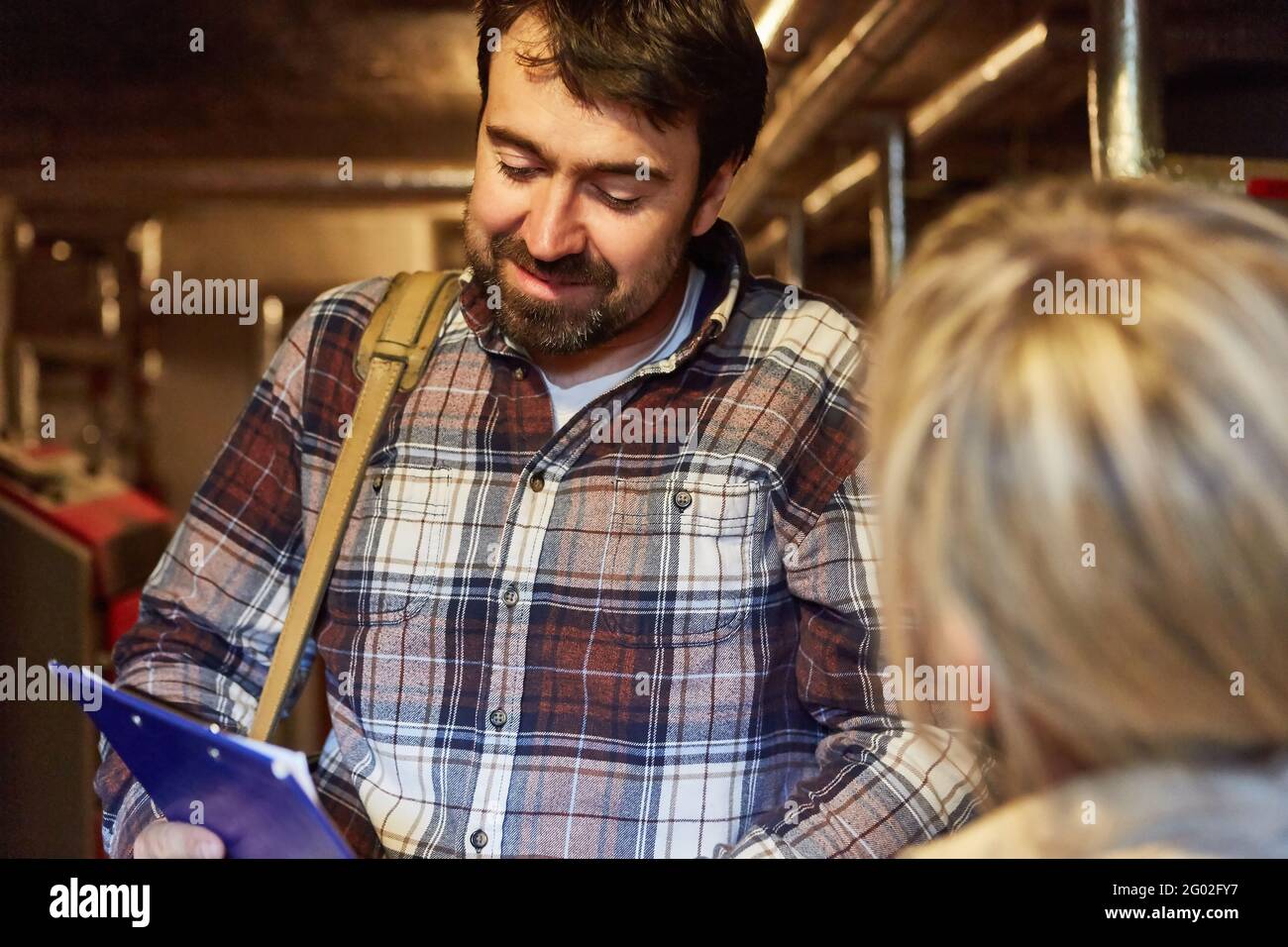 A heating installer from customer service talking to a customer in the ...