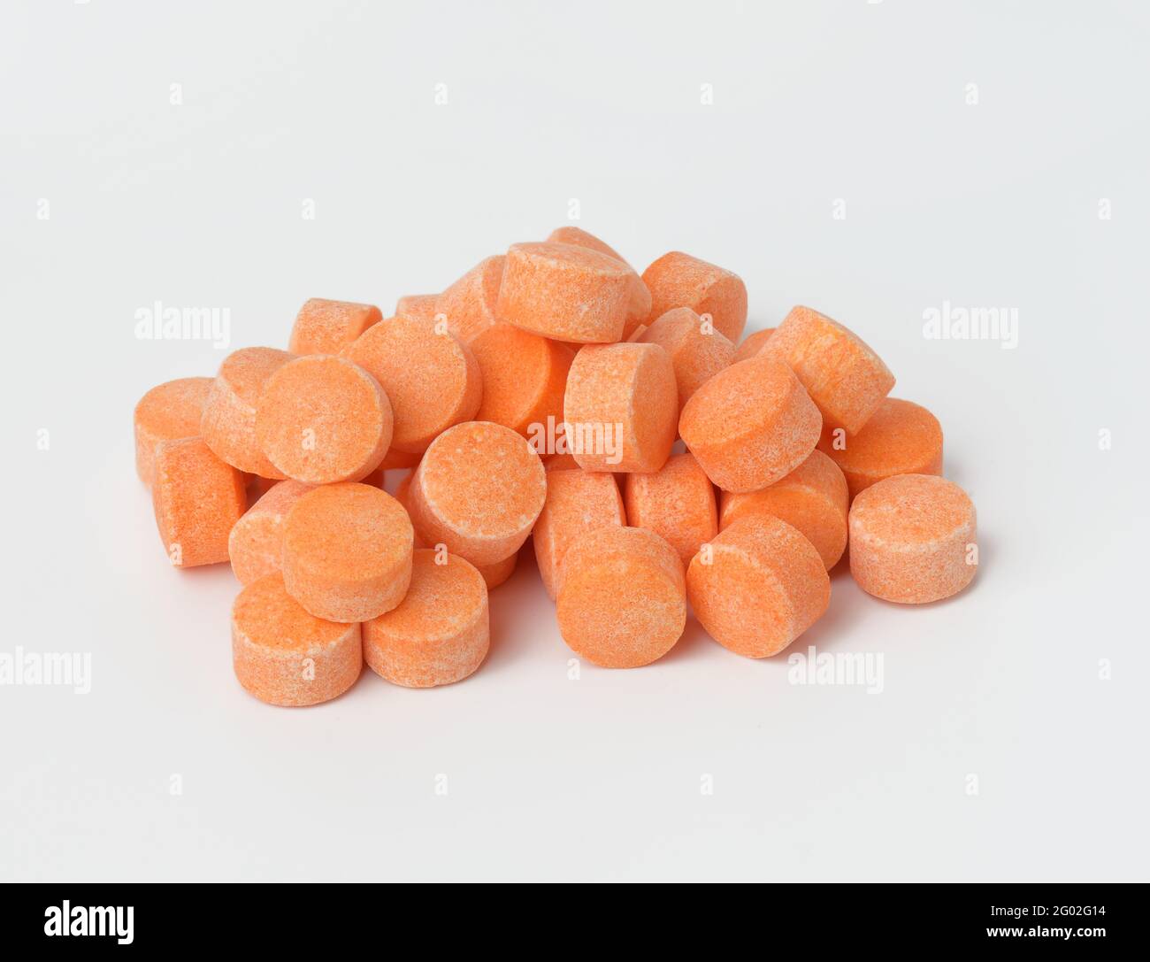 orange pills on white background, vitamin C, close up Stock Photo - Alamy