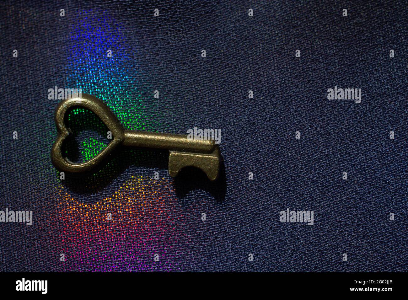 Key with heart on colorful fabric a symbol of love as Valentine concept ...