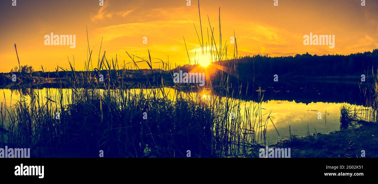 Summer landscape with sunset on the lake. Beautiful orange sundown or ...