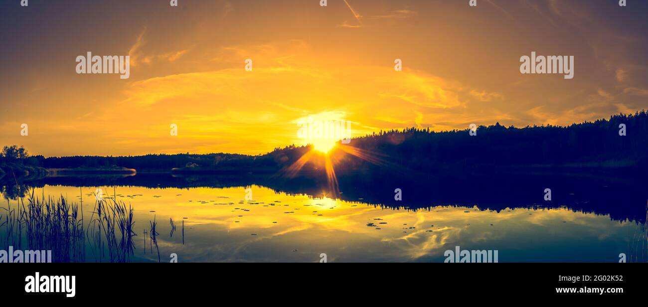 Summer landscape with sunset on the lake. Beautiful orange sundown or ...