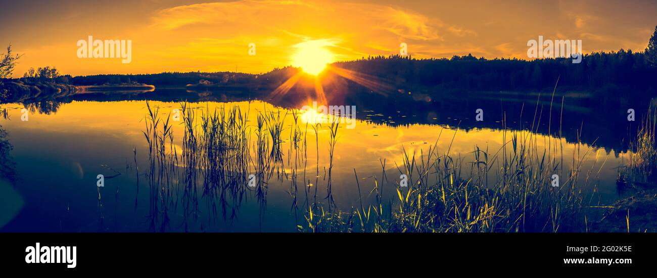 Summer landscape with sunset on the lake. Beautiful orange sundown or ...