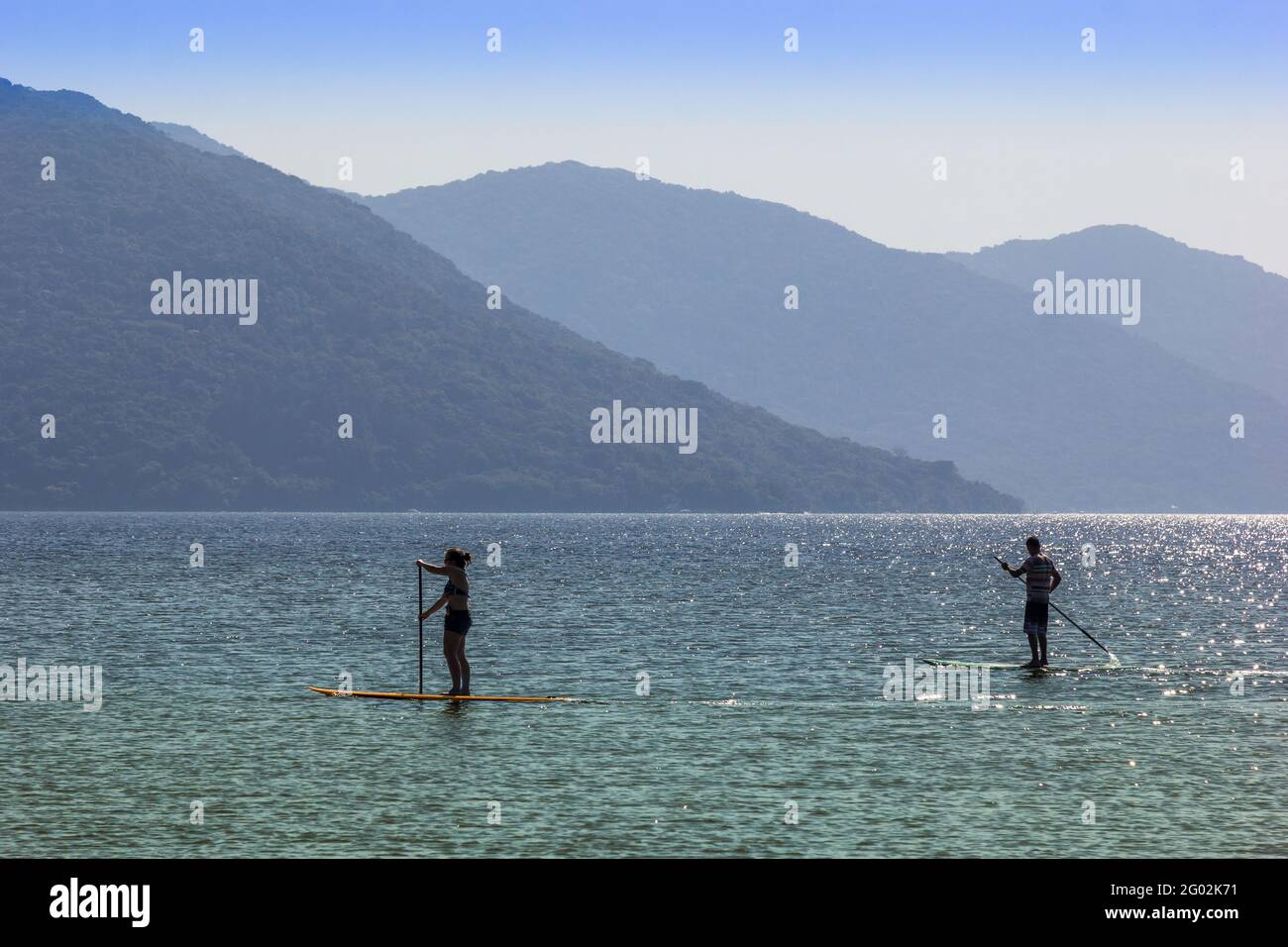 People paddling on stand-up paddleboards in a lake inFlorianopolis ...