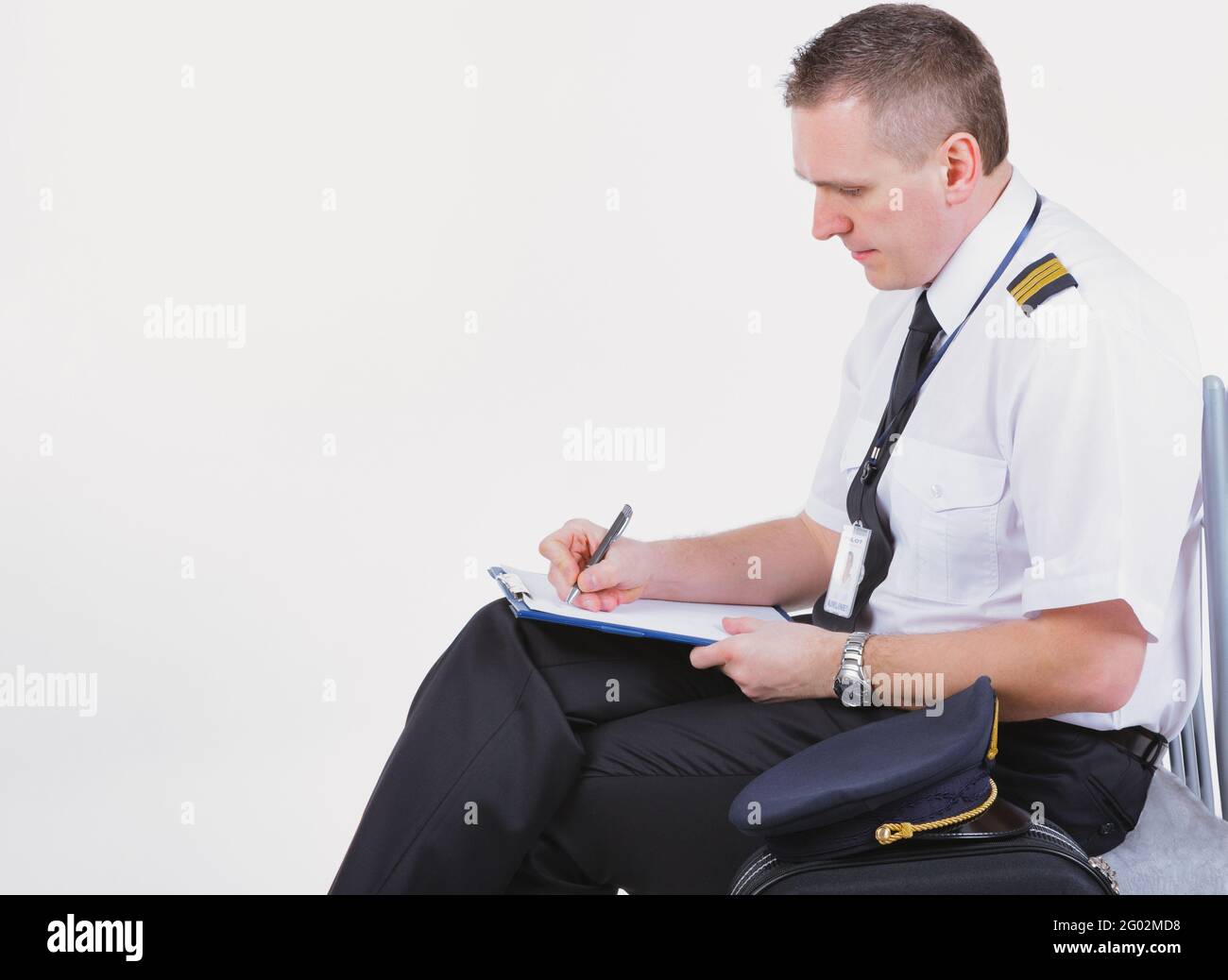 Airline captain pilot fills out the paperwork before the flight. A cap ...