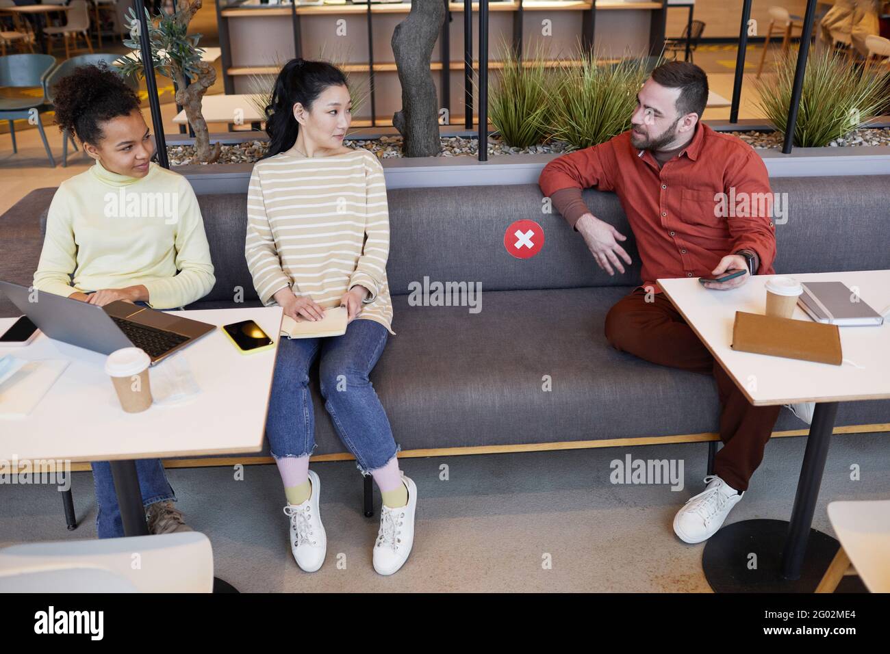 High angle portrait of people chatting in food court or cafe with ...
