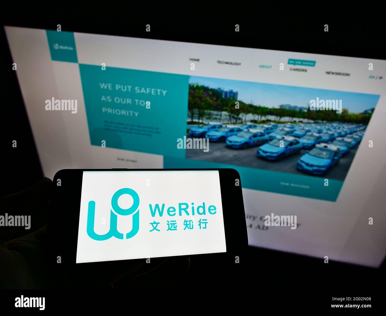 Person holding cellphone with logo of Chinese autonomous driving ...