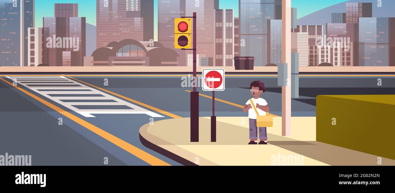 african american schoolboy with backpack standing on city street near ...