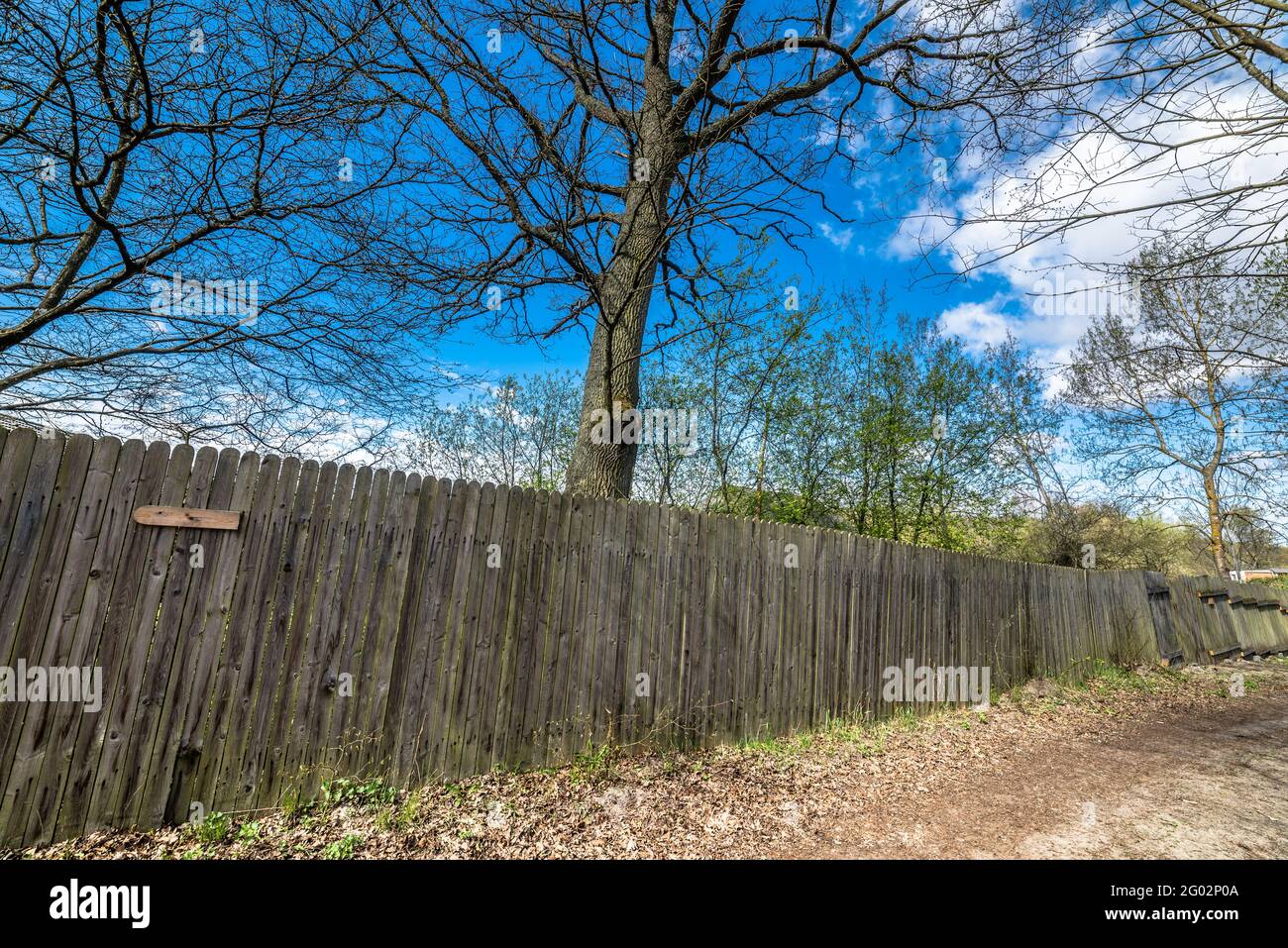 Rural road and wooden fence, spring landscape with countryside scene ...