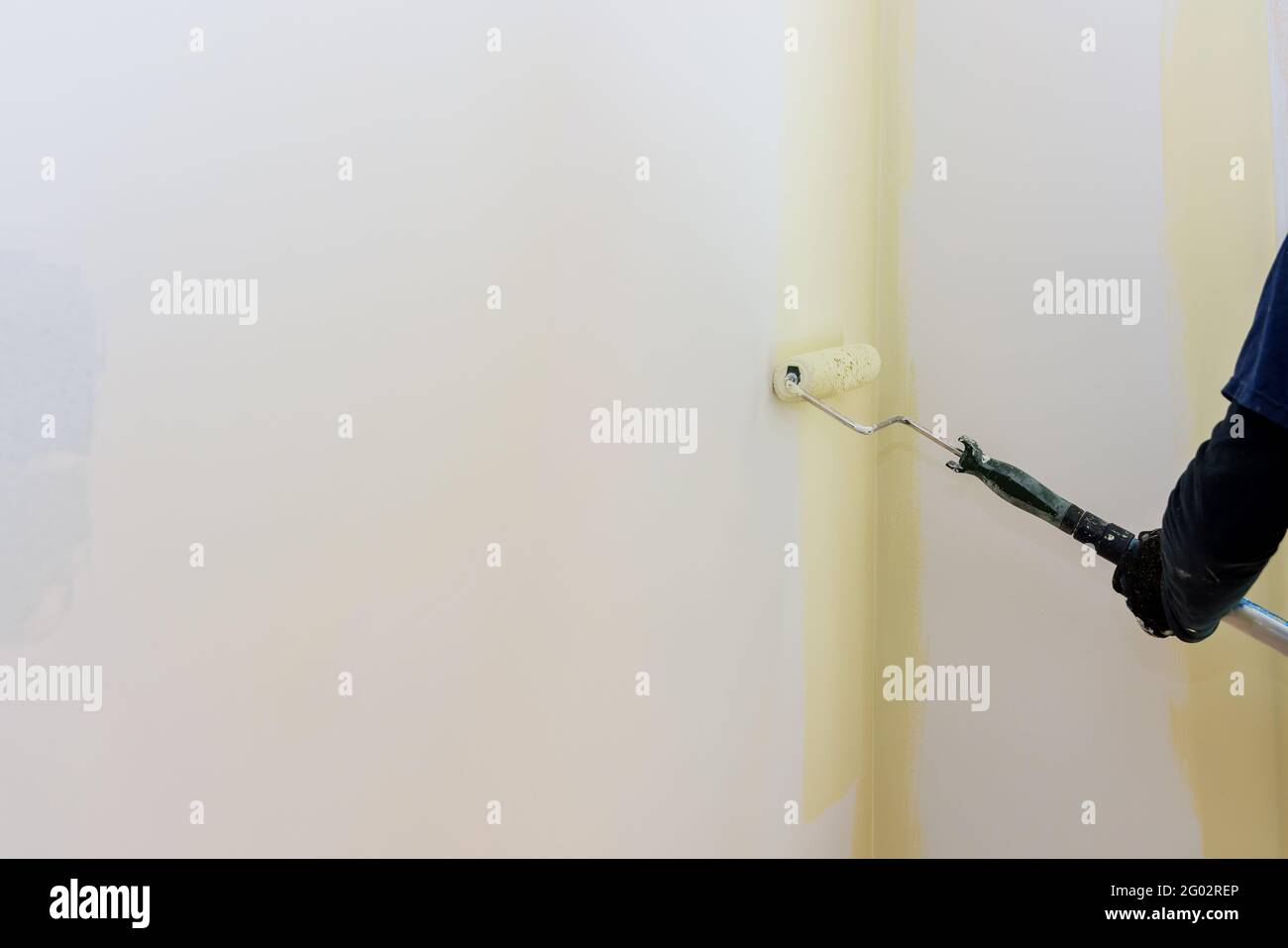 Worker painting wall in room, apartment renovation, repair home Stock ...