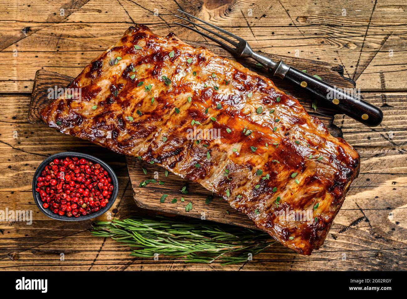 Grilled and smoked pork spare ribs. Wooden background. Top view Stock ...