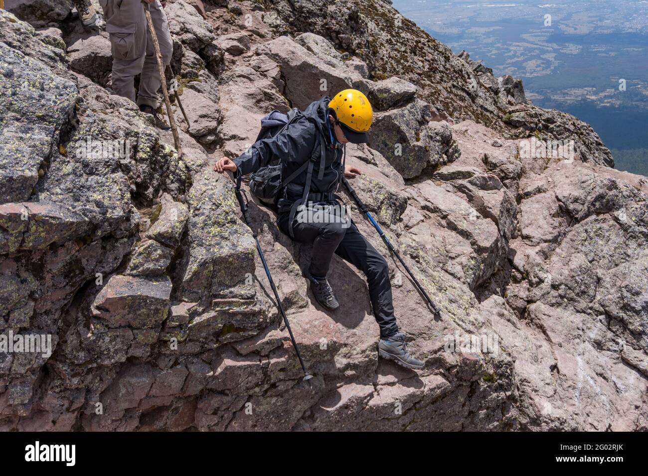 Closeup shot of a hiker on top of the rocky terrain in Malinche volcano ...