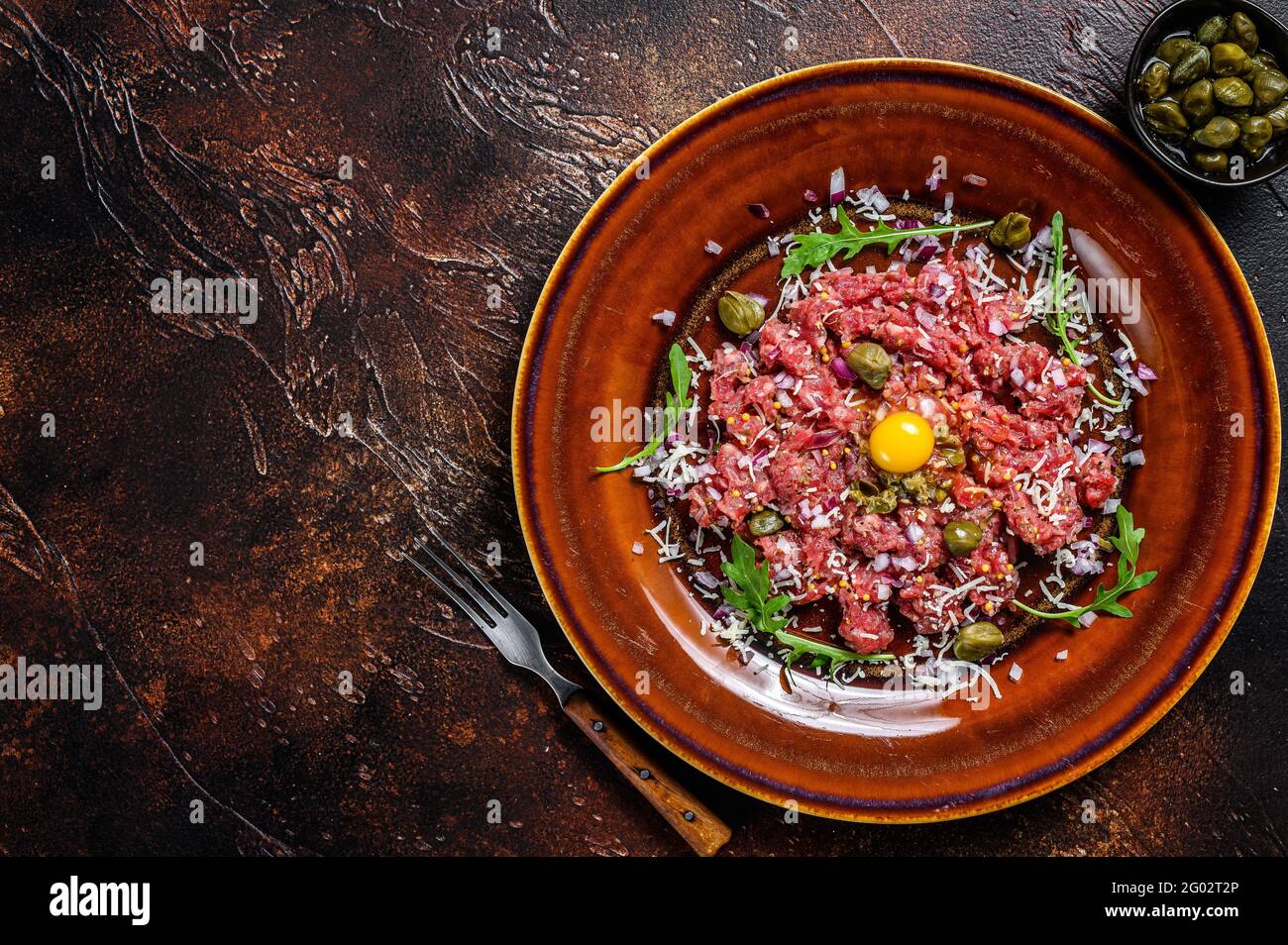 Beef steak tartare with raw egg yolk, pickled capers and Parmesan ...
