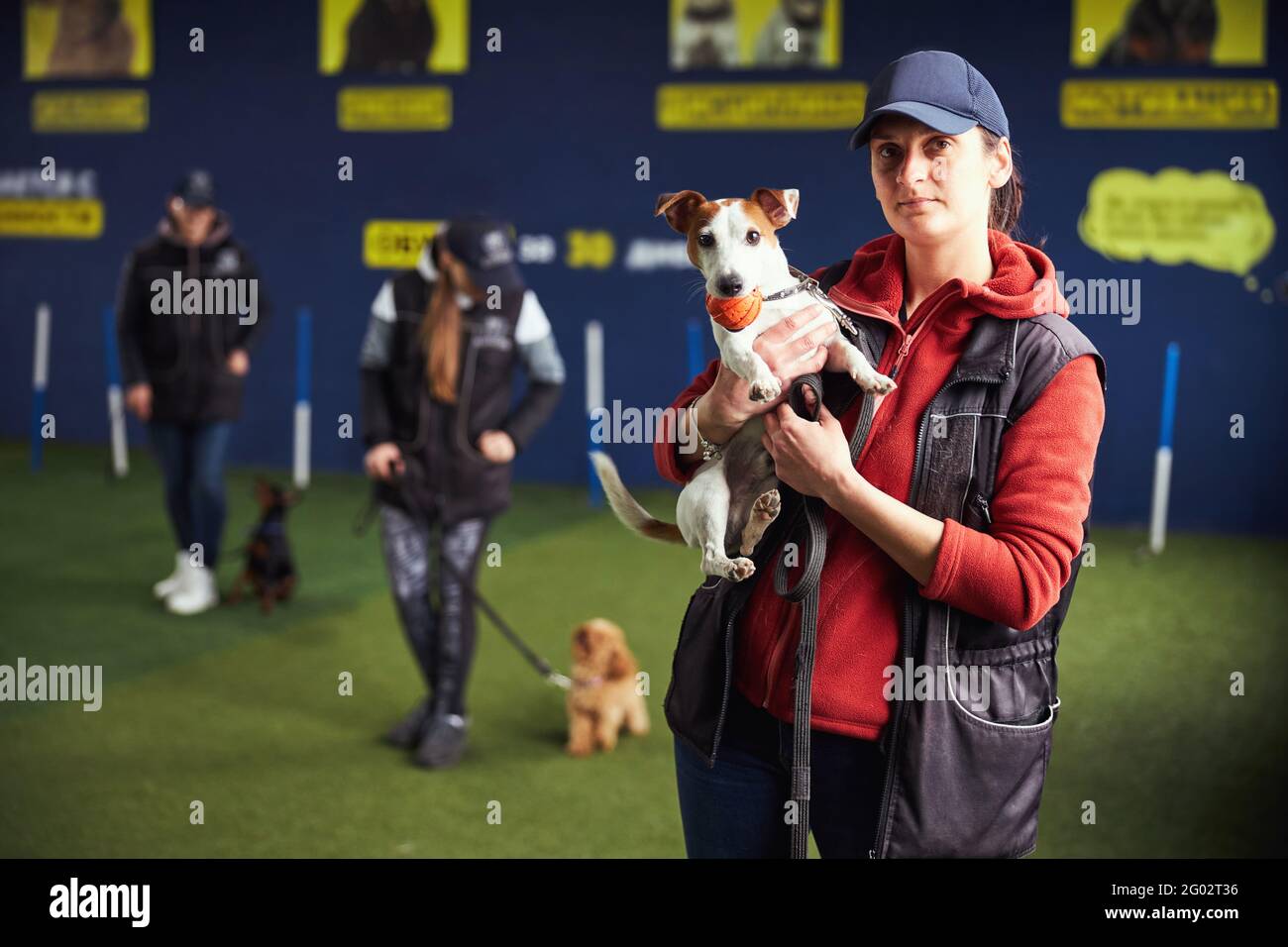 Dog trainer and a cute puppy posing for the camera Stock Photo - Alamy