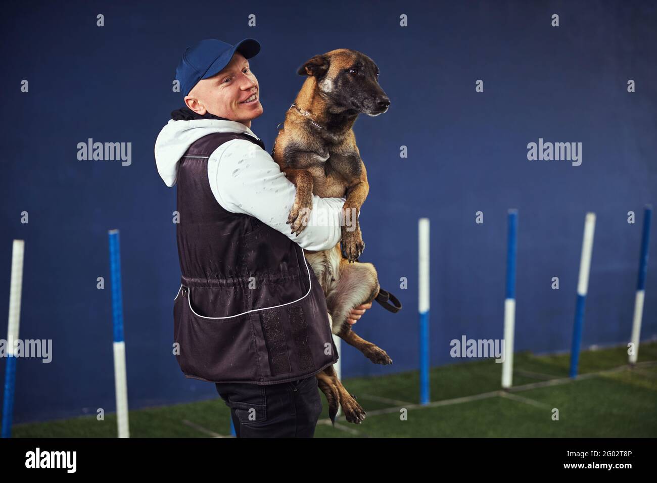 Dog handler and a cute canine in the obedience school Stock Photo - Alamy