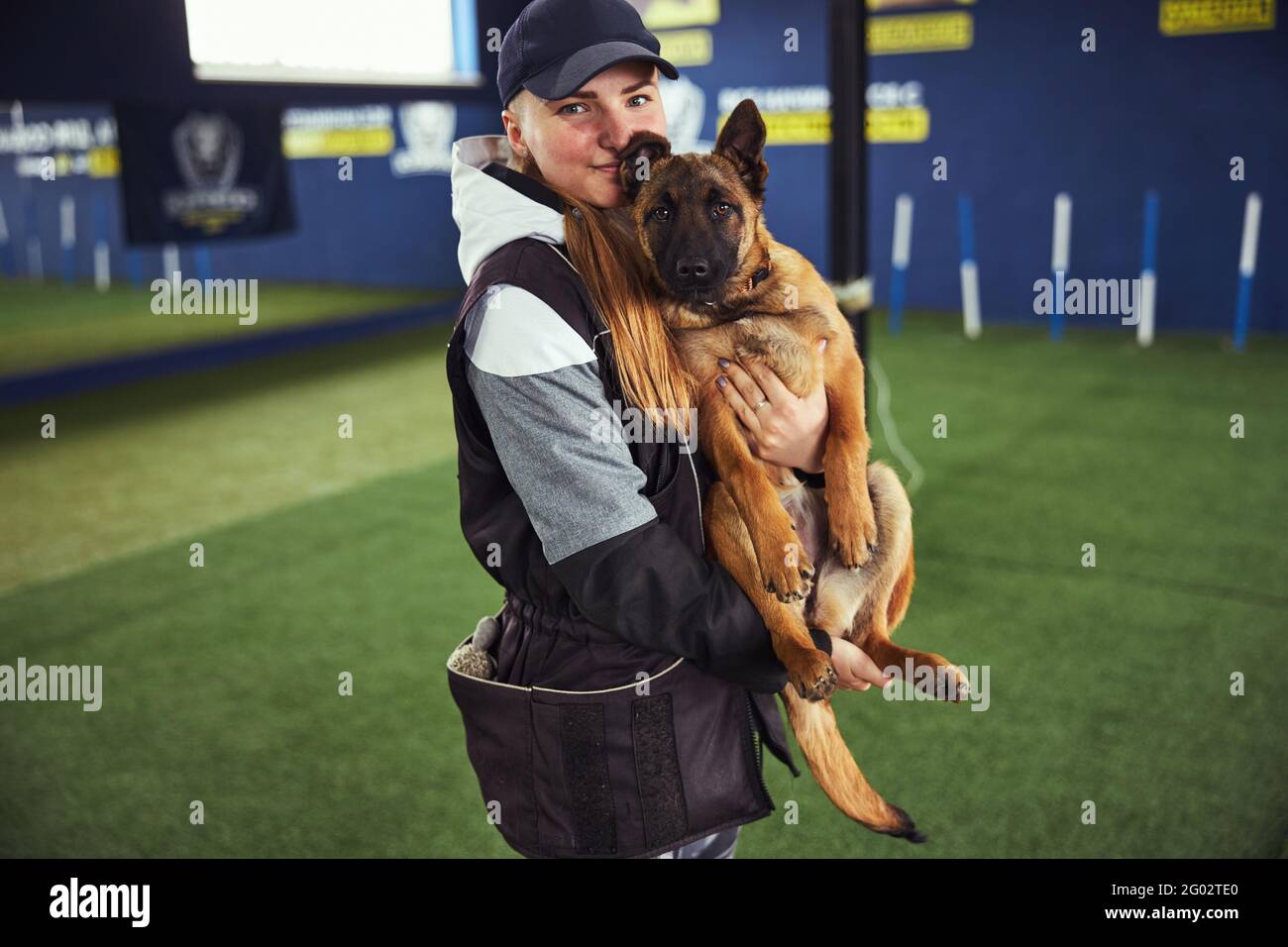 Female instructor and a cute puppy posing for the camera Stock Photo ...