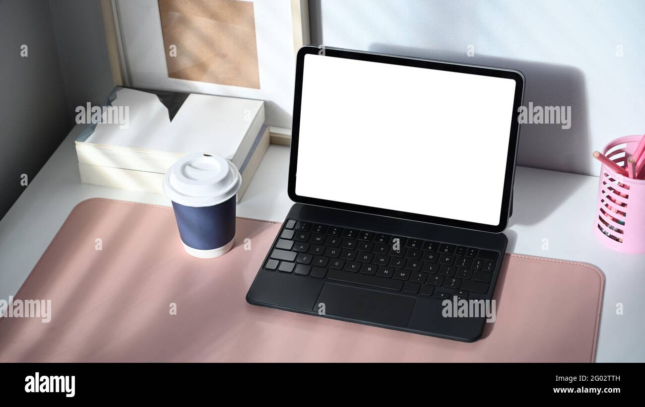 Close up view digital table with wireless keyboard on white office desk ...