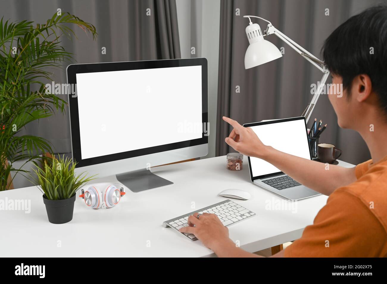 Side view of young man hand pointing on screen of computer while siting ...