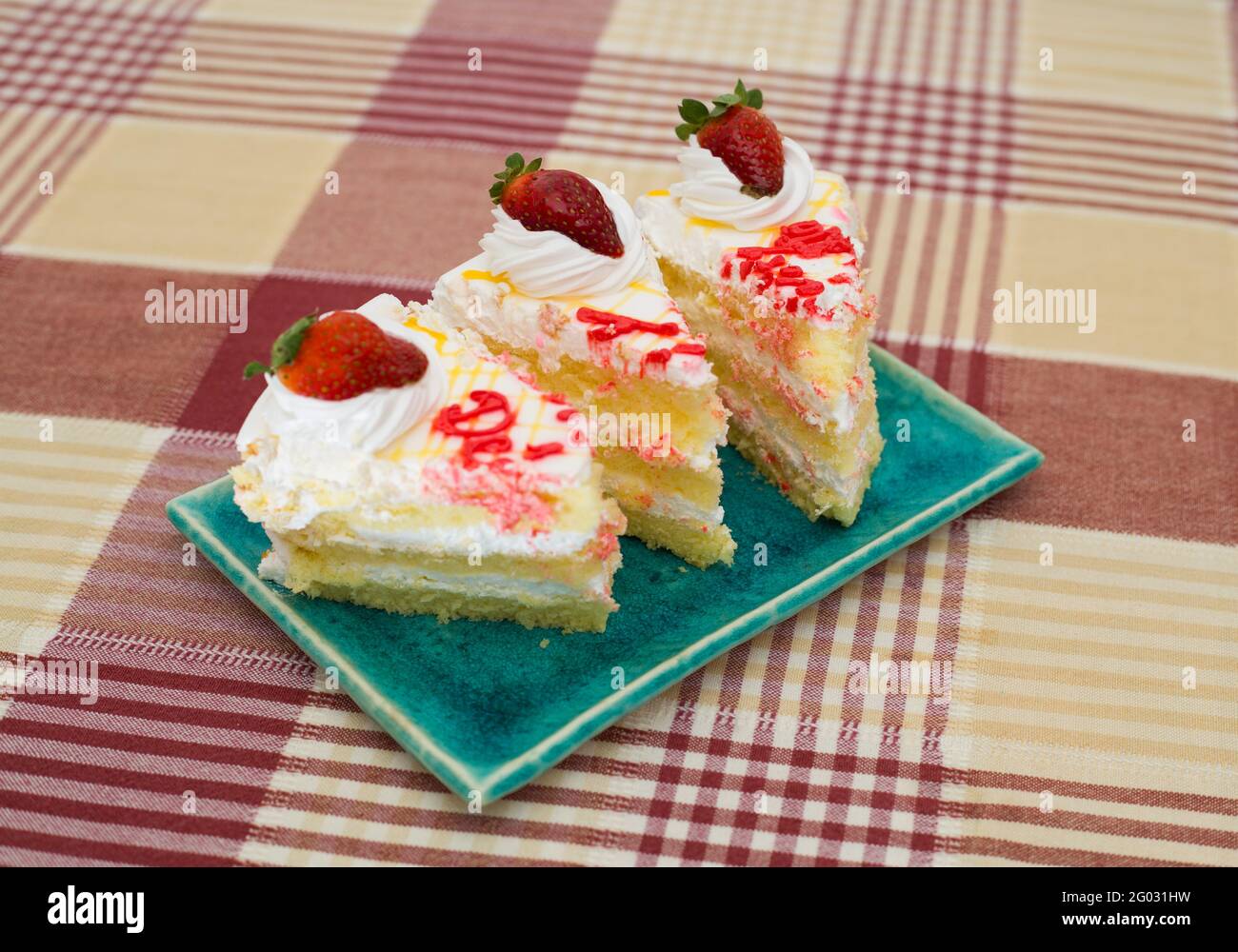 Closeup of white vanilla sponge cake slices on a blue plate Stock Photo ...