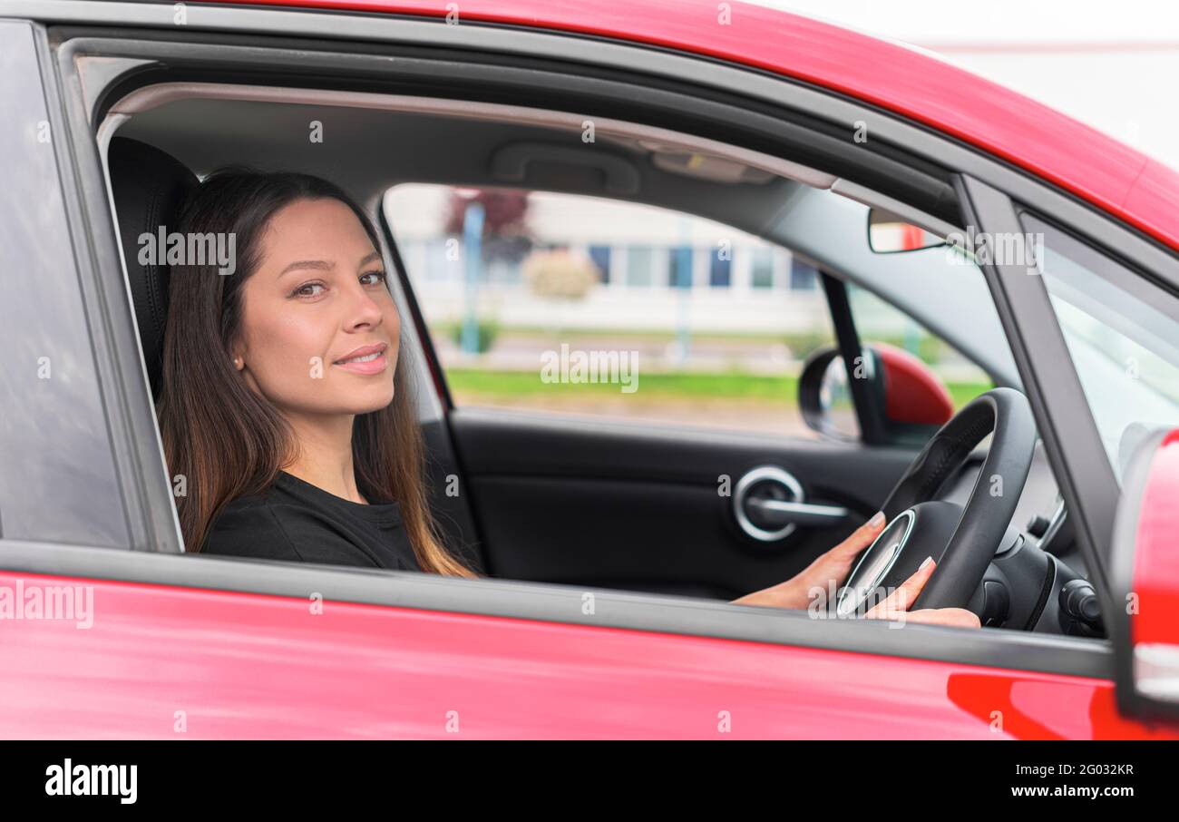 Beautiful young woman driving a car Stock Photo - Alamy