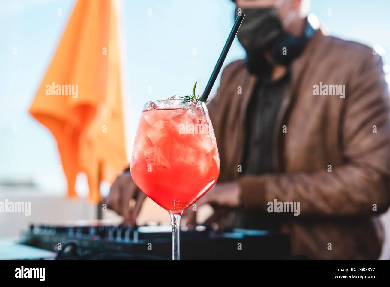 Close up of a special cocktail at beach party - Dj playing music at ...