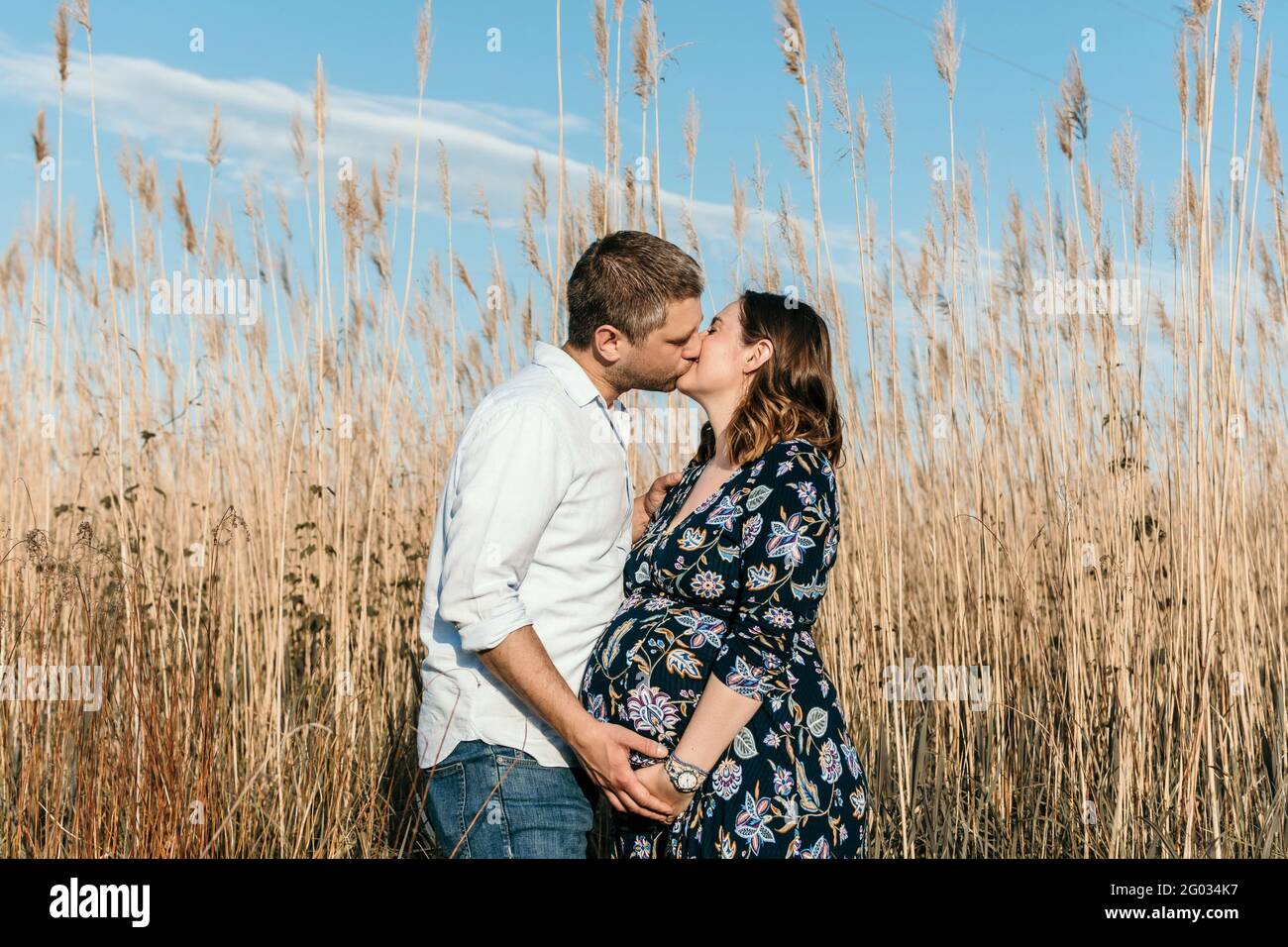 Beautiful young couple expecting a baby. Outdoor photo of happy parents ...
