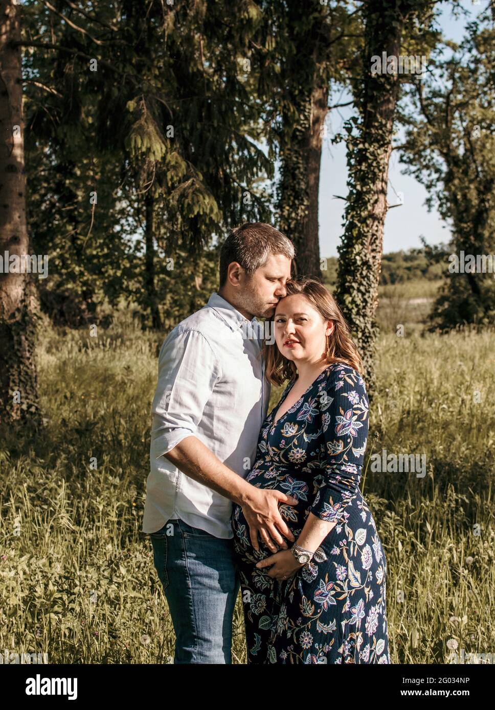 Beautiful young couple expecting a baby. Outdoor photo of happy parents ...