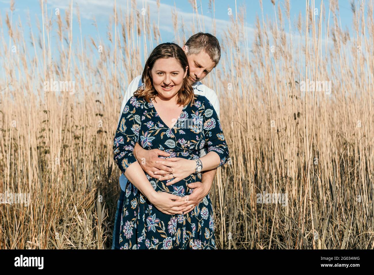 Beautiful young couple expecting a baby. Outdoor photo of happy parents ...