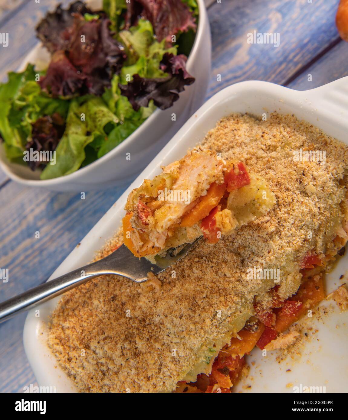 Salmon Parmentier recipe with hazelnuts, young salad leaves Stock Photo ...