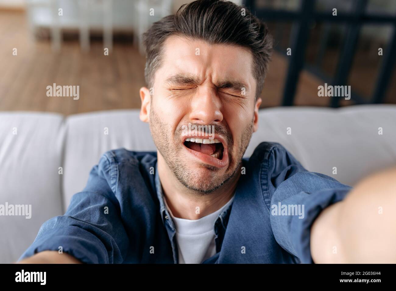 Selfie of a sad upset young caucasian man with a beard, in casual ...