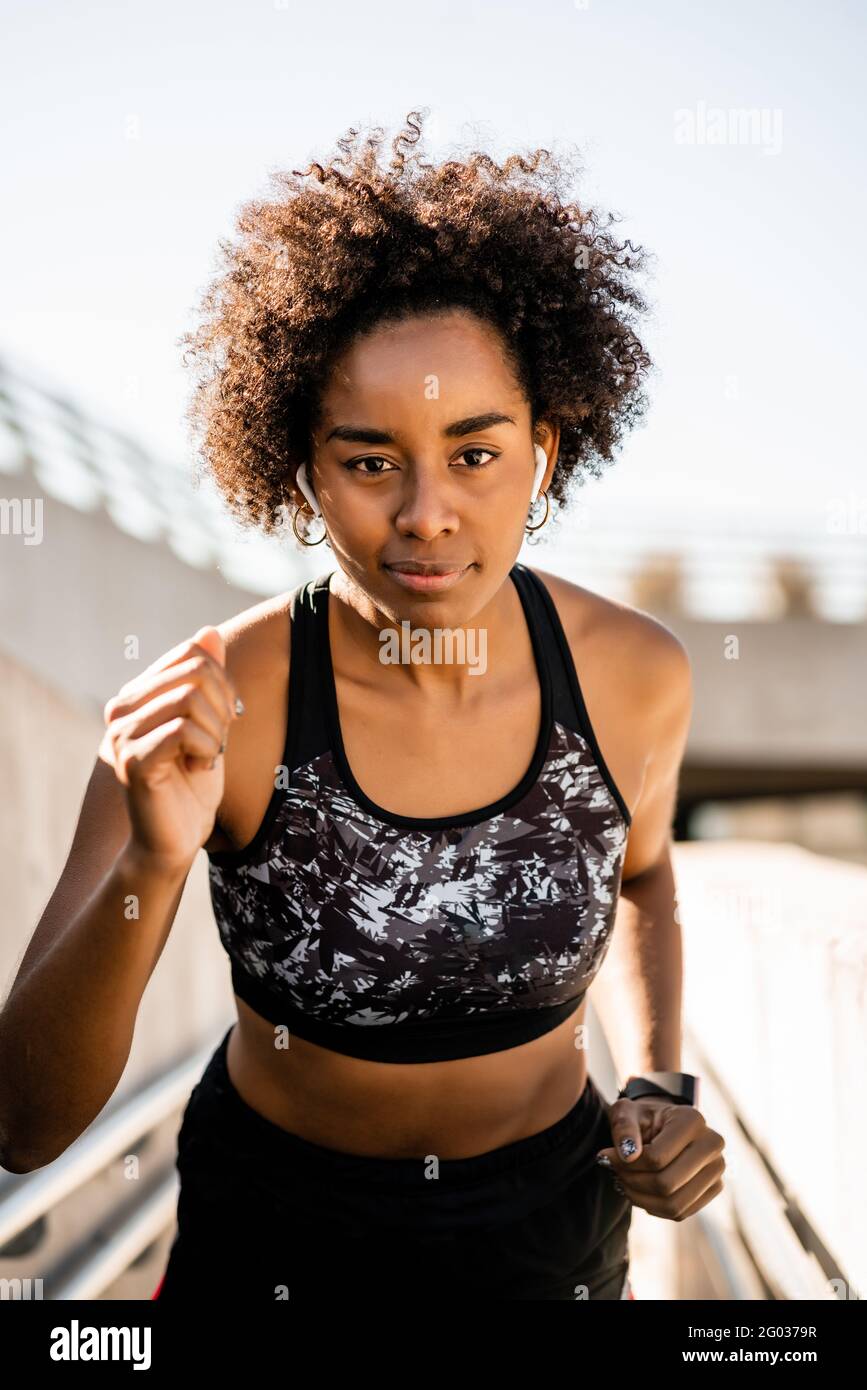 Afro athlete woman running outdoors Stock Photo - Alamy