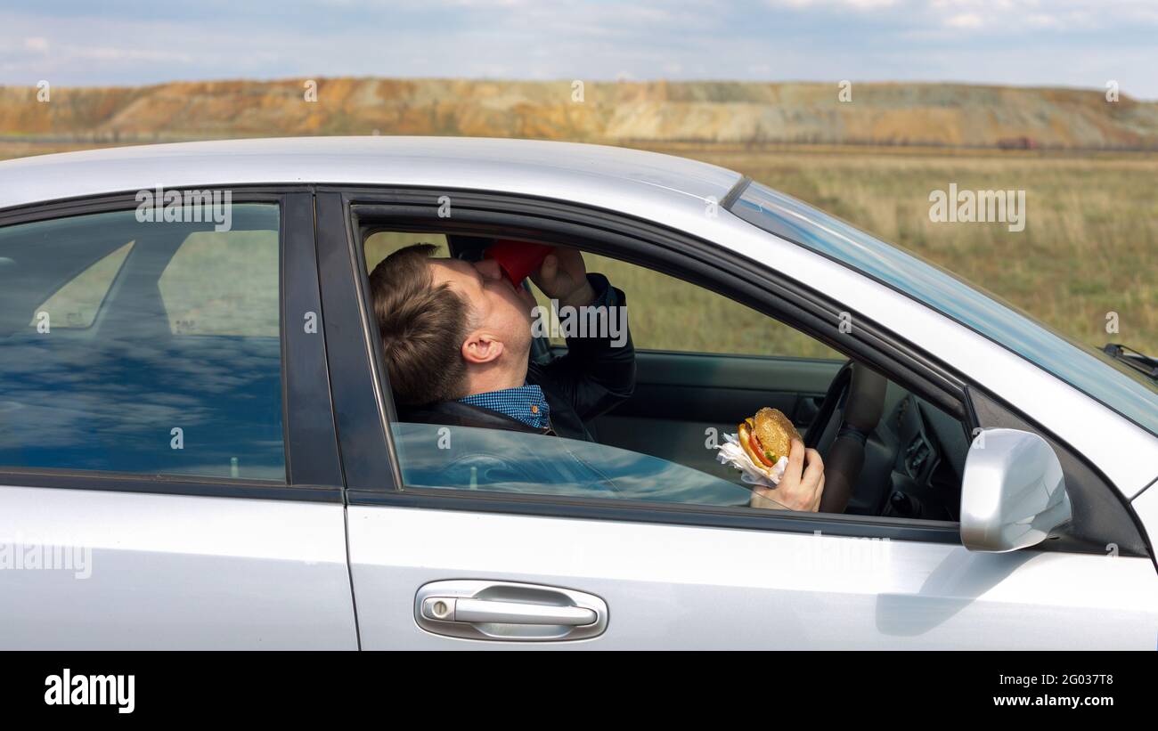 The manager eats lunch at wheel in the car Stock Photo - Alamy