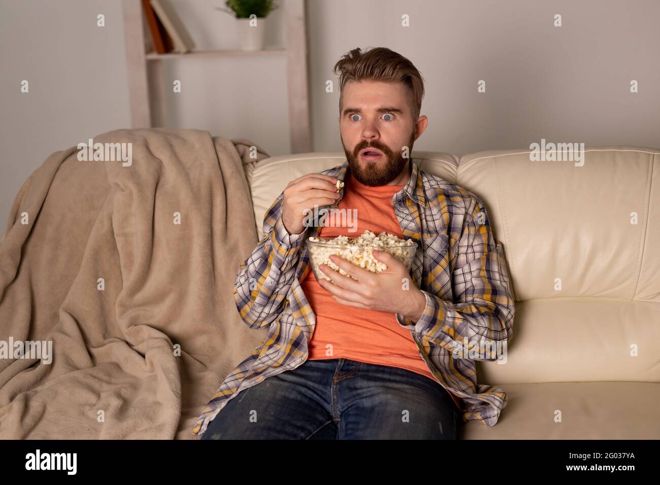 Single man on the couch watching TV Stock Photo - Alamy