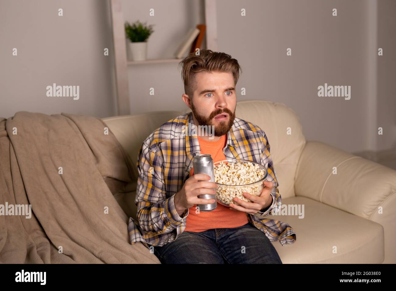 Single man on the couch watching TV Stock Photo - Alamy