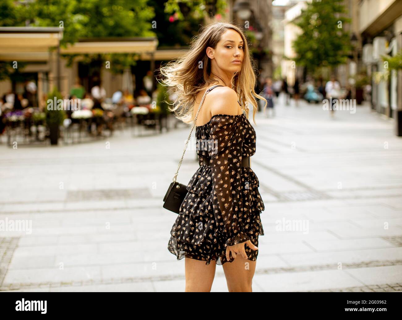 Pretty young long hair brunette woman walking on the city street Stock ...