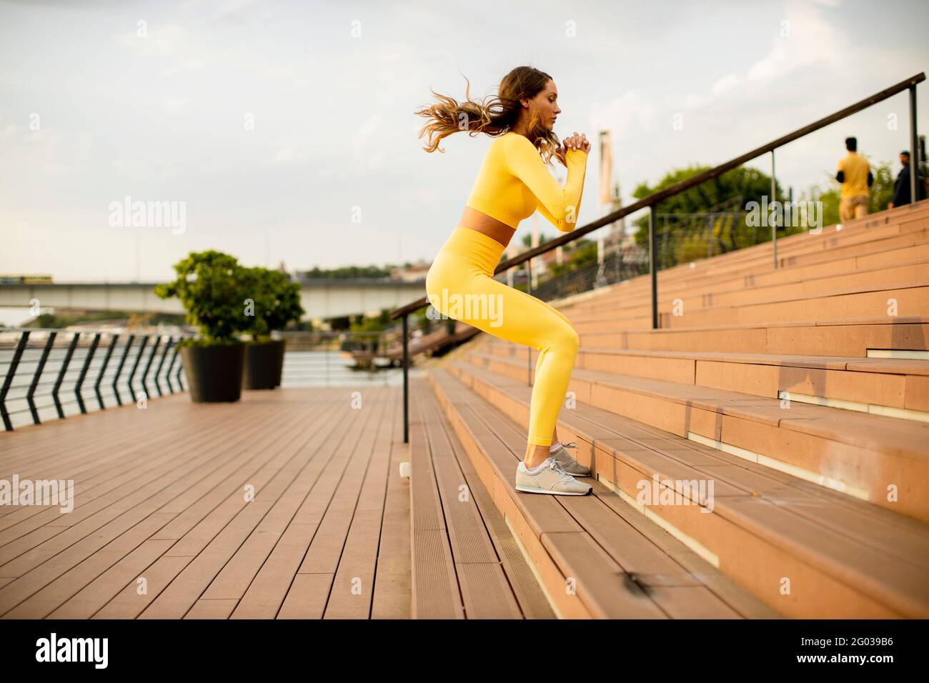 Young woman jogging up stairs hi-res stock photography and images - Alamy