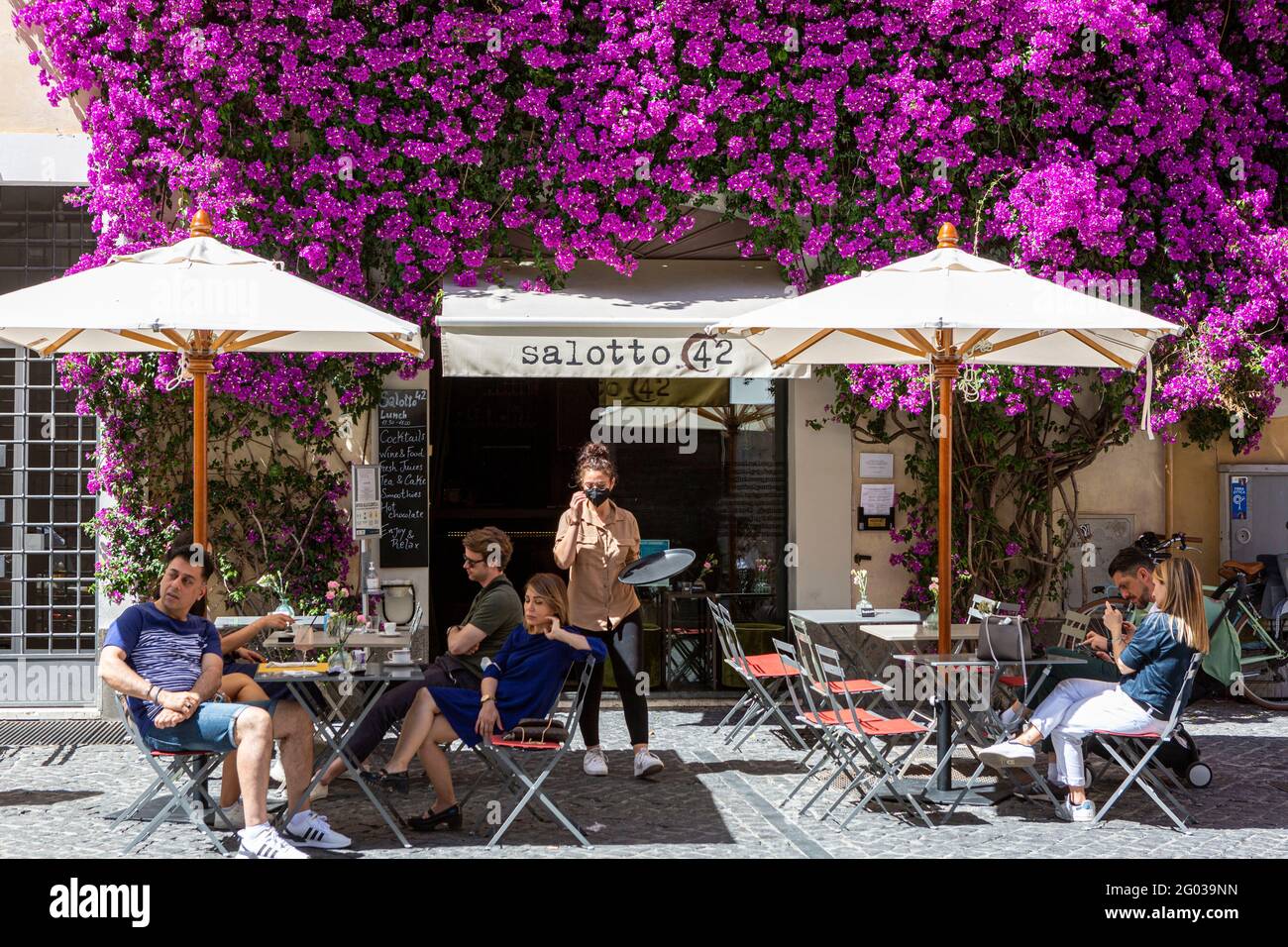 People sit outside a bar in Rome Stock Photo - Alamy