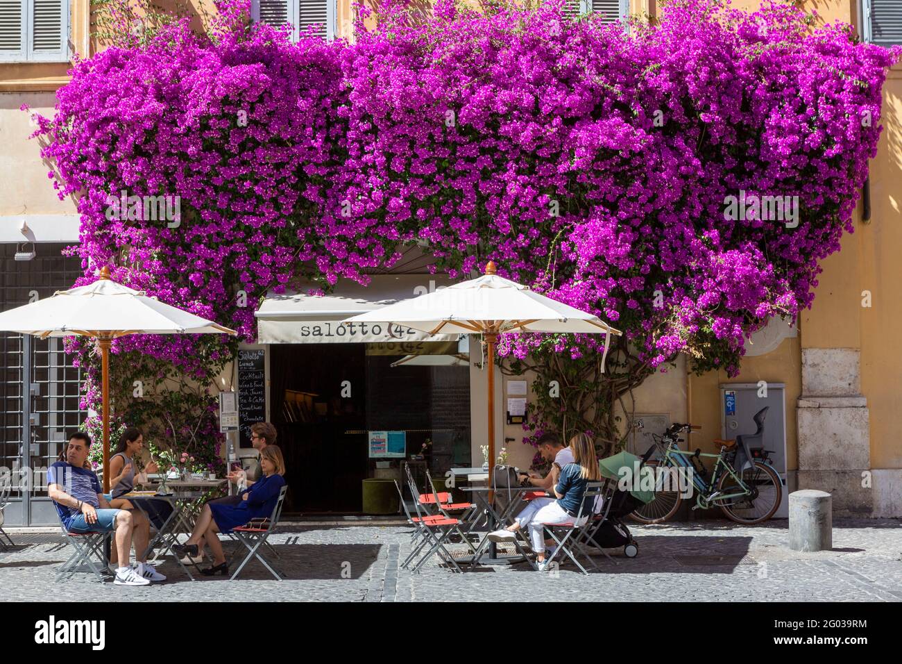 People sit outside a bar in Rome Stock Photo - Alamy