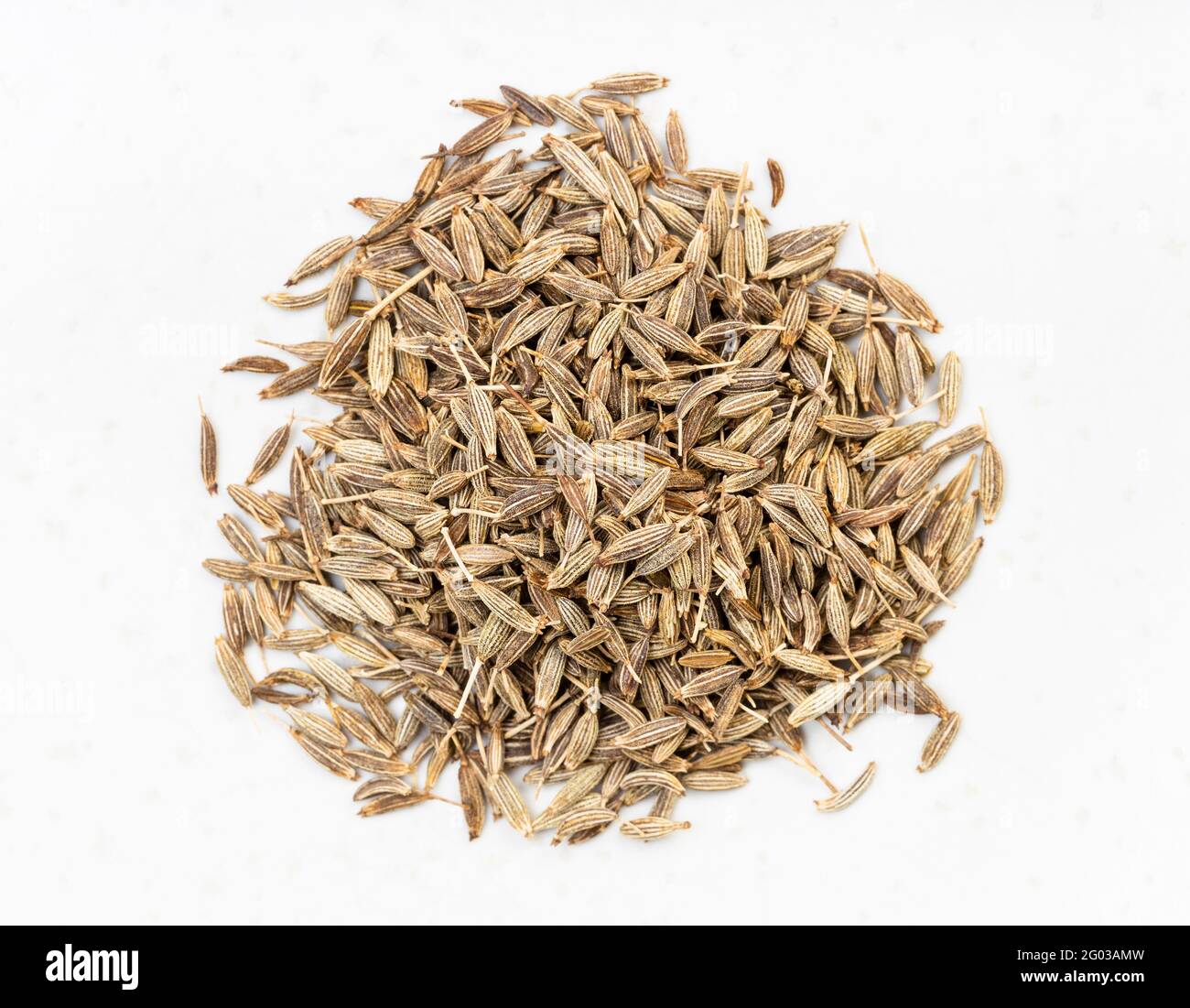 top view of pile of cumin (cuminum cyminum) seeds close up on gray ...