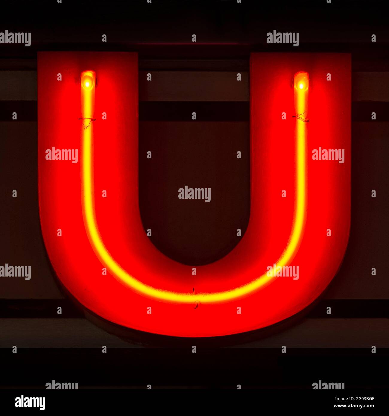 Red glowing neon letter U at night Stock Photo - Alamy