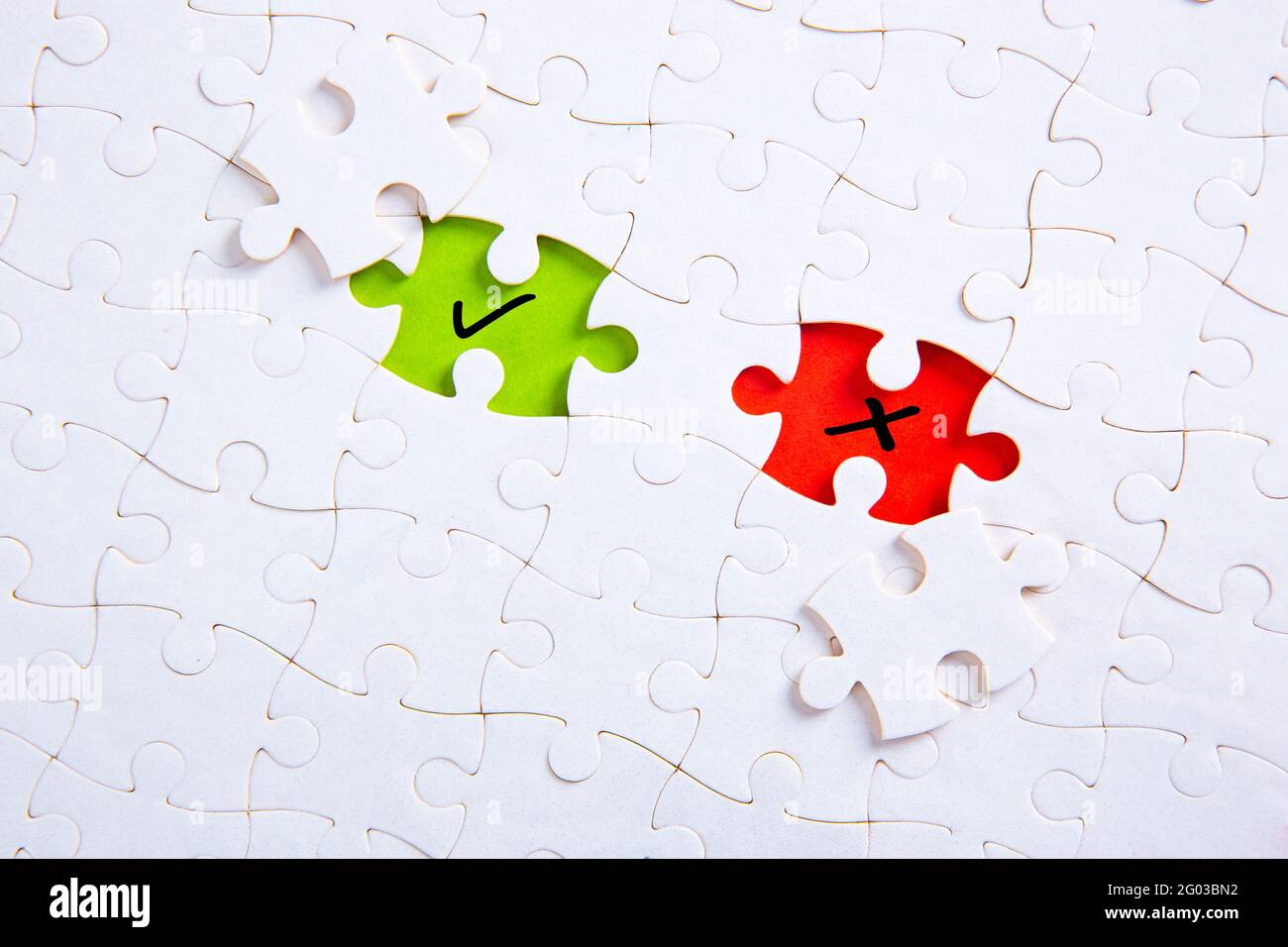 Missing puzzle pieces with check mark and cross symbols Stock Photo - Alamy