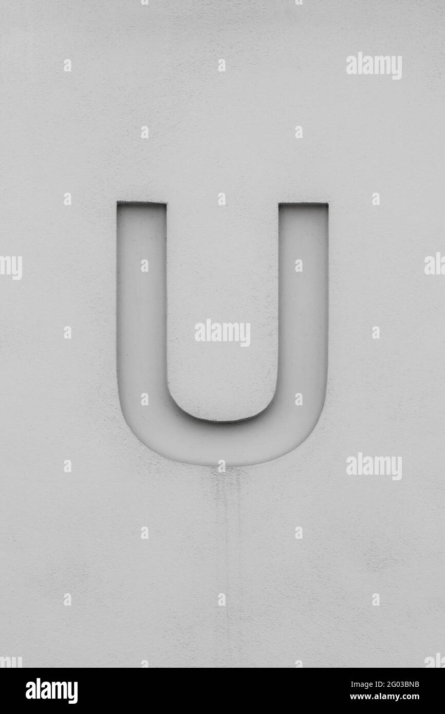 Capital letter U negative relief in gray concrete Stock Photo - Alamy