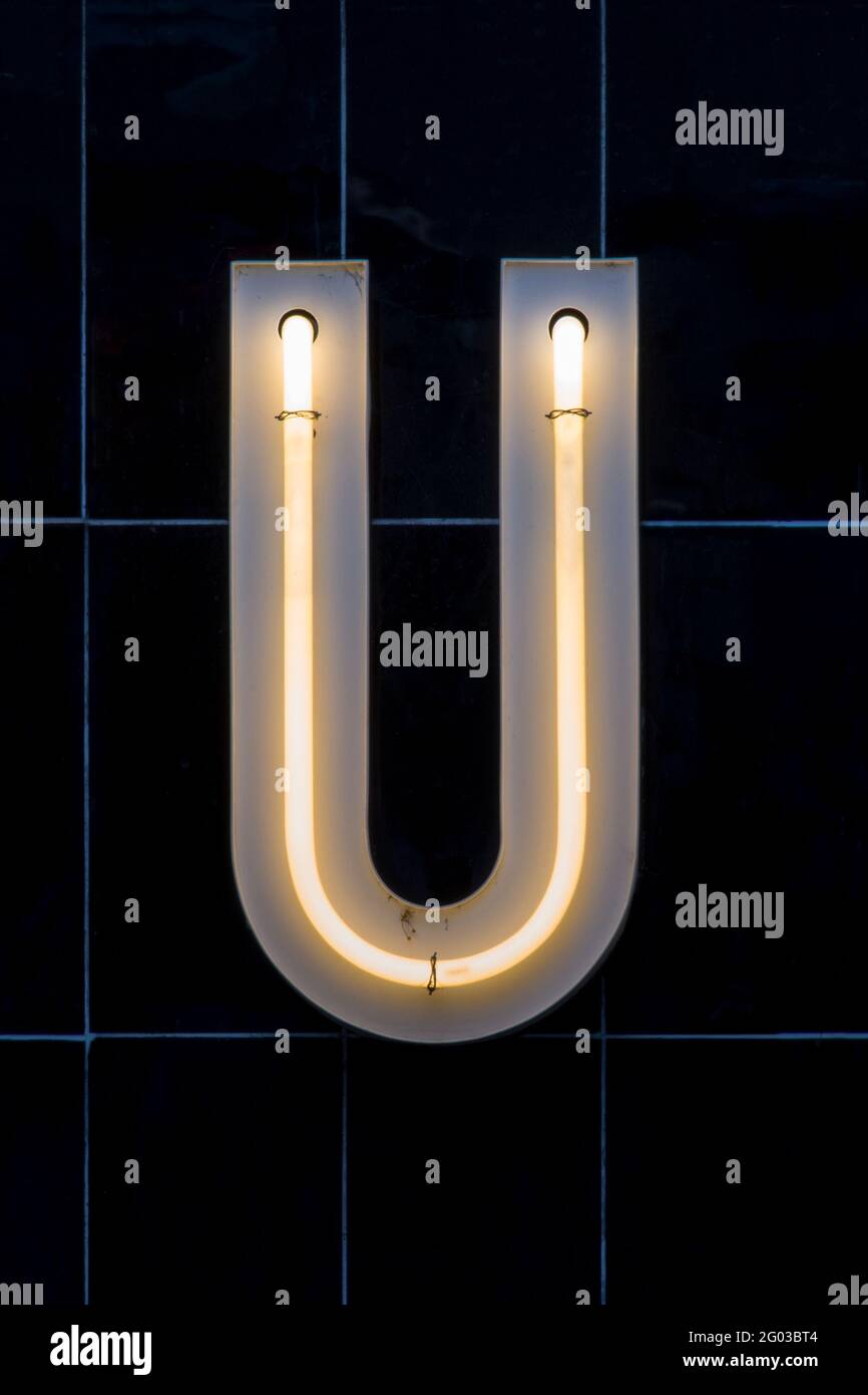 White neon letter U glowing in the dark Stock Photo - Alamy
