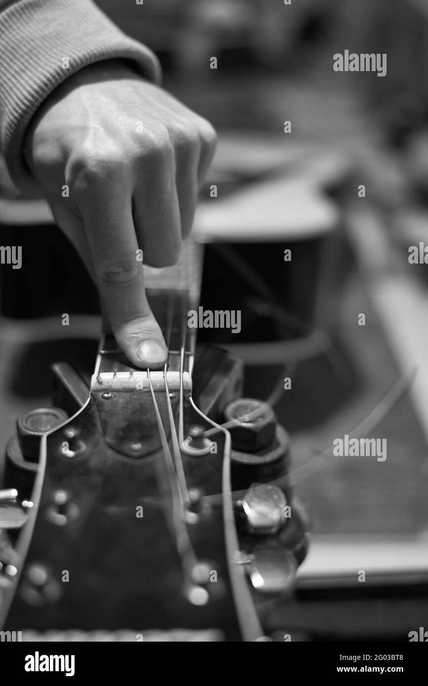 A service worker checks the sound of the guitar for further tuning ...