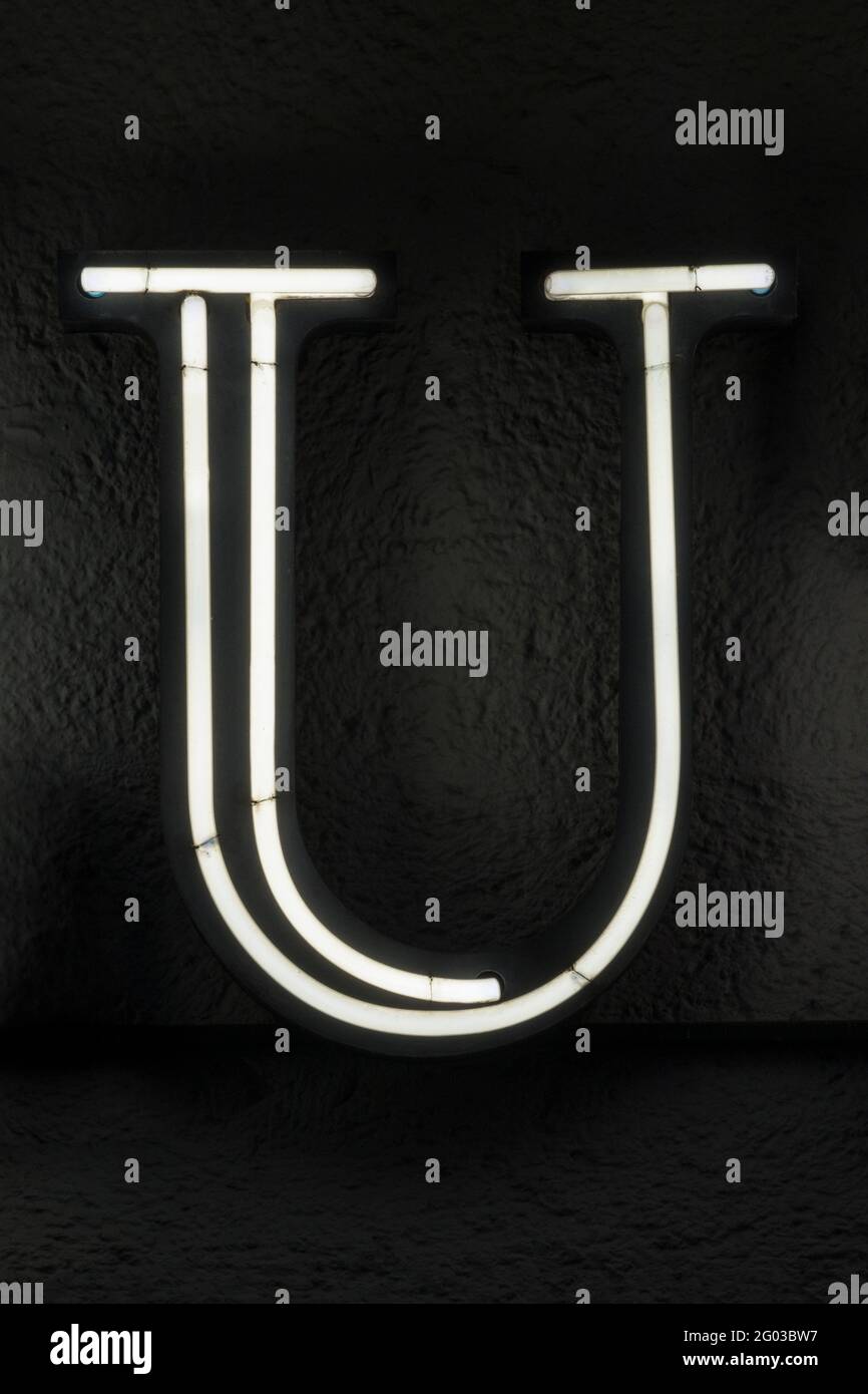 White neon letter U glowing in the dark Stock Photo - Alamy