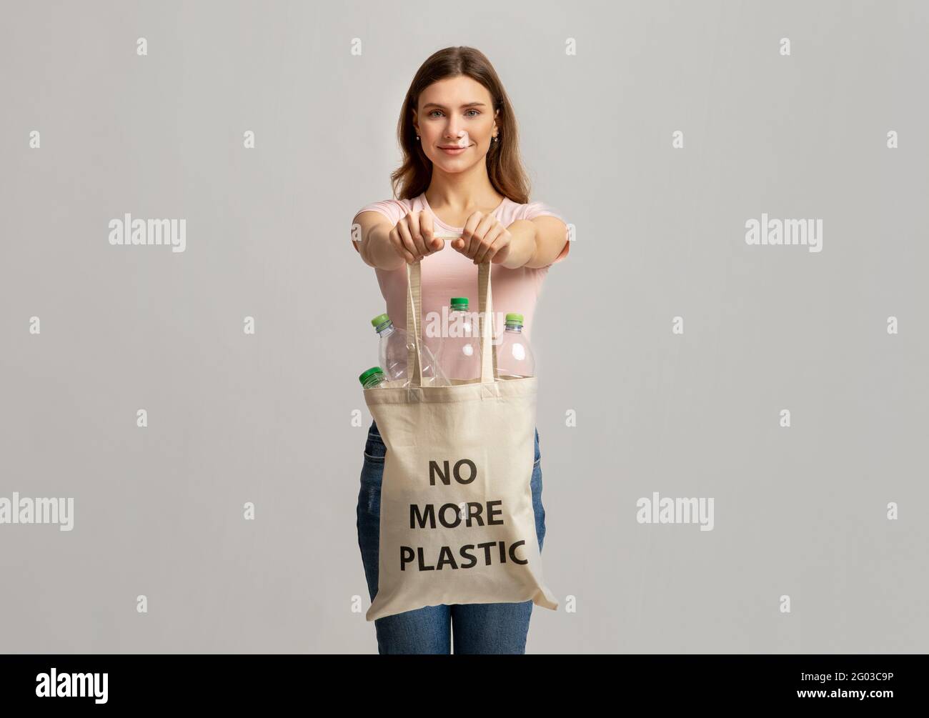 No More Plastic. Female Carrying Tote Bag With Empty Bottles For ...